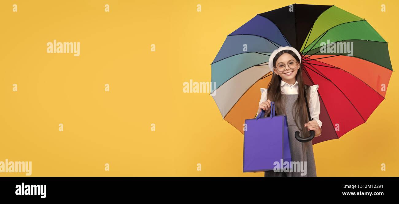 happy teen girl under colorful umbrella in autumn season hold shopping ...