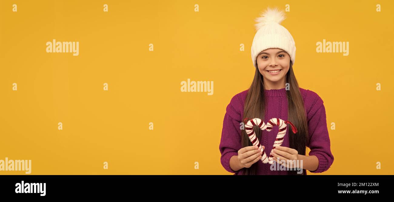 happy new year. happy child in winter hat. kid with candy sticks. teen ...