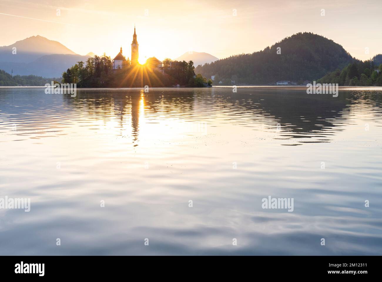 View of lake Bled at in spring with the small island and Assumption of ...