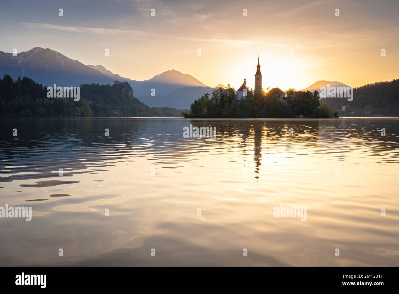 View of lake Bled at in spring with the small island and Assumption of ...