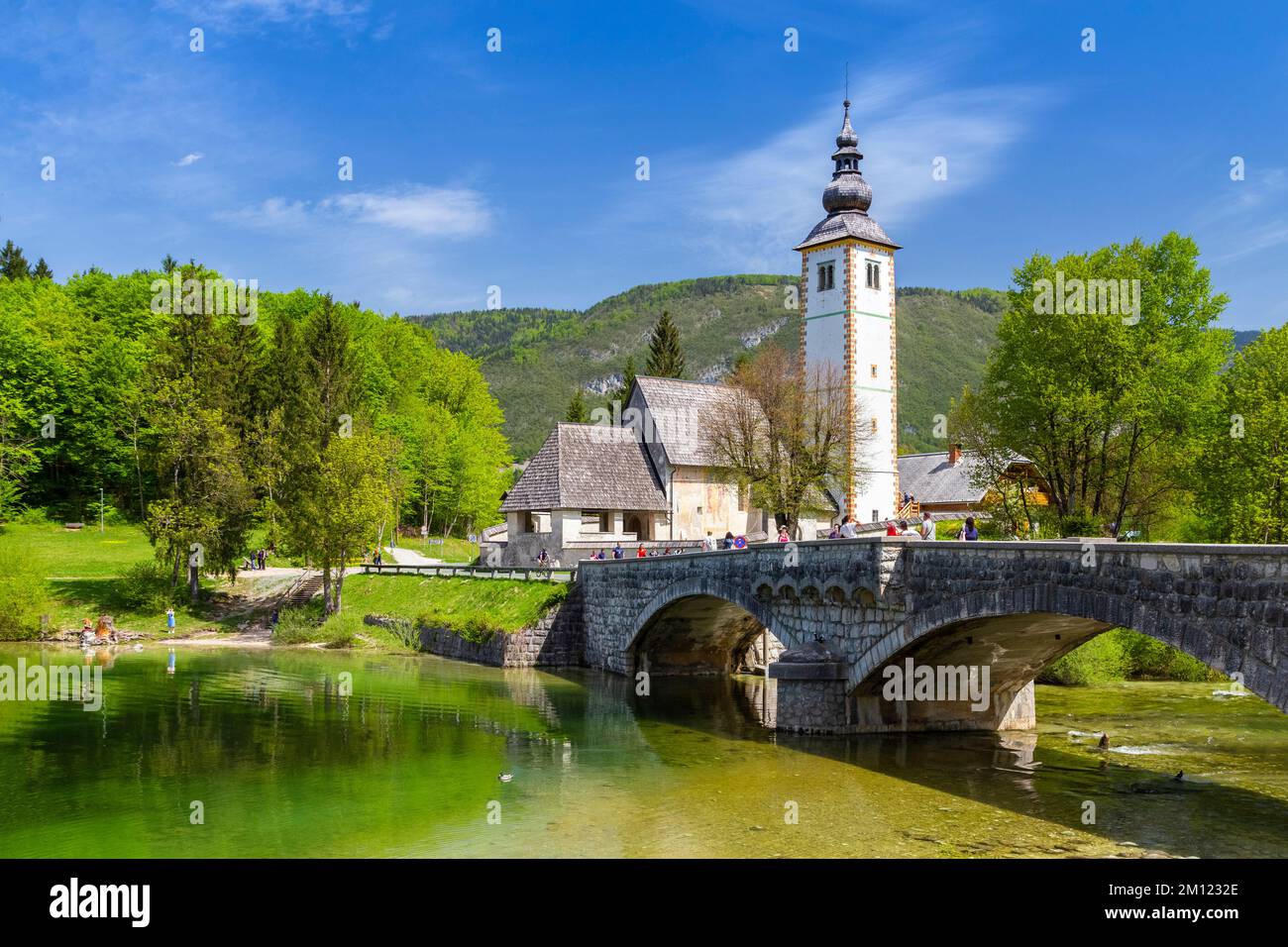 Church of St. John the Baptist and the stone bridge by the Bohinj lake ...