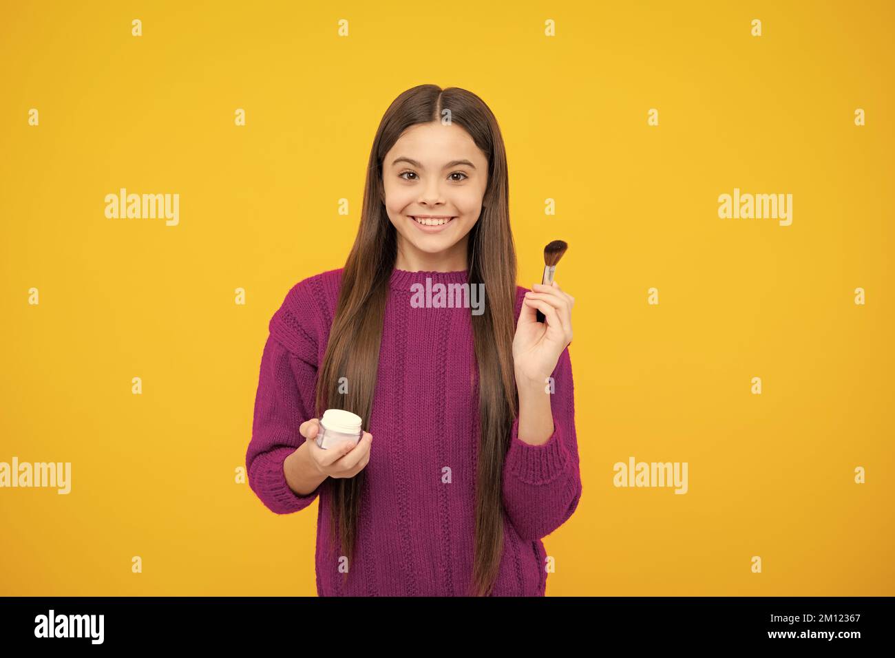 Kids make up products. Makeup teen child artist apply face powder with ...