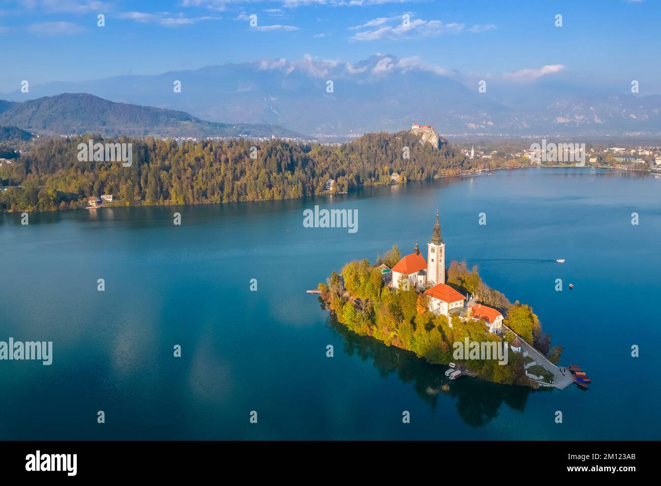 Aerial view of Bled island on Lake Bled in autumn at sunset. Bled ...