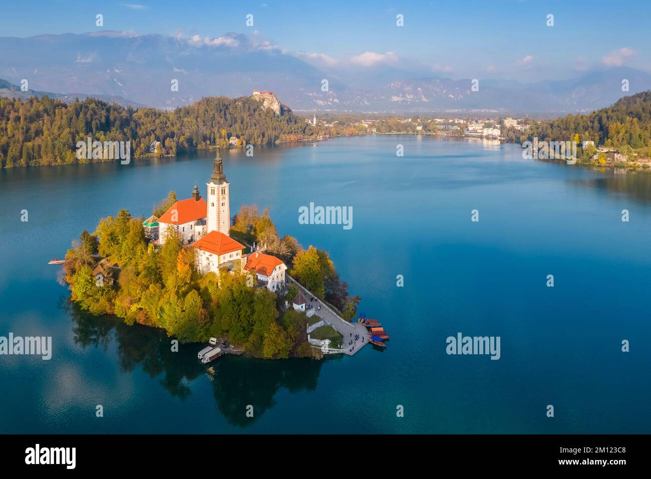 Aerial view of Bled island on Lake Bled in autumn at sunset. Bled ...