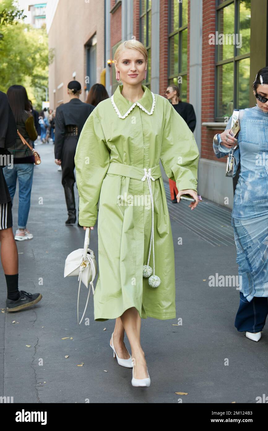 MILAN, ITALY - SEPTEMBER 21, 2022: Woman with green dress and white bag ...