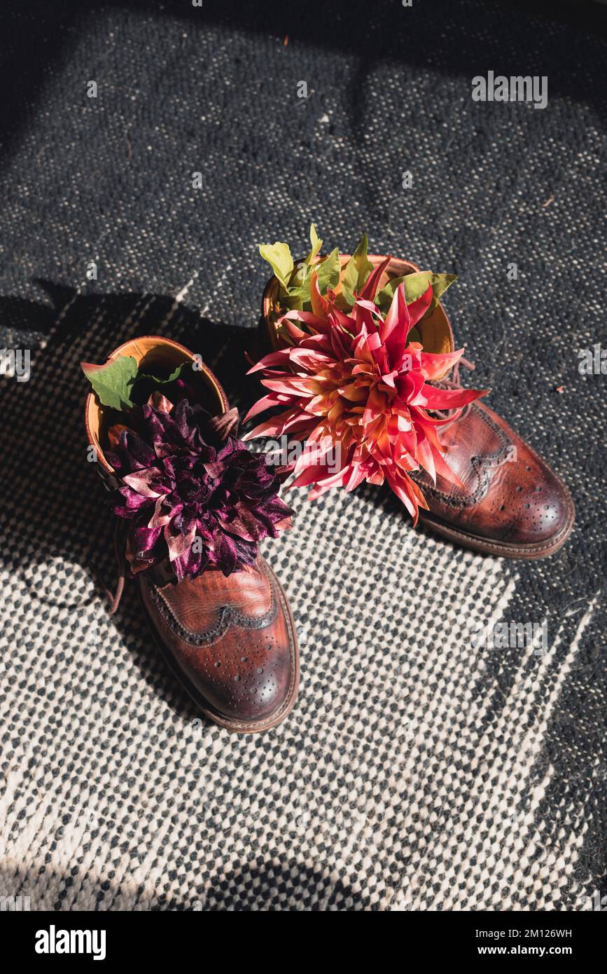 Two flowers in open men shoes hi-res stock photography and images - Alamy