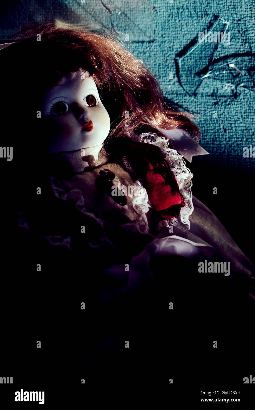 Old fashioned doll lying on the floor next to broken glass Stock Photo ...