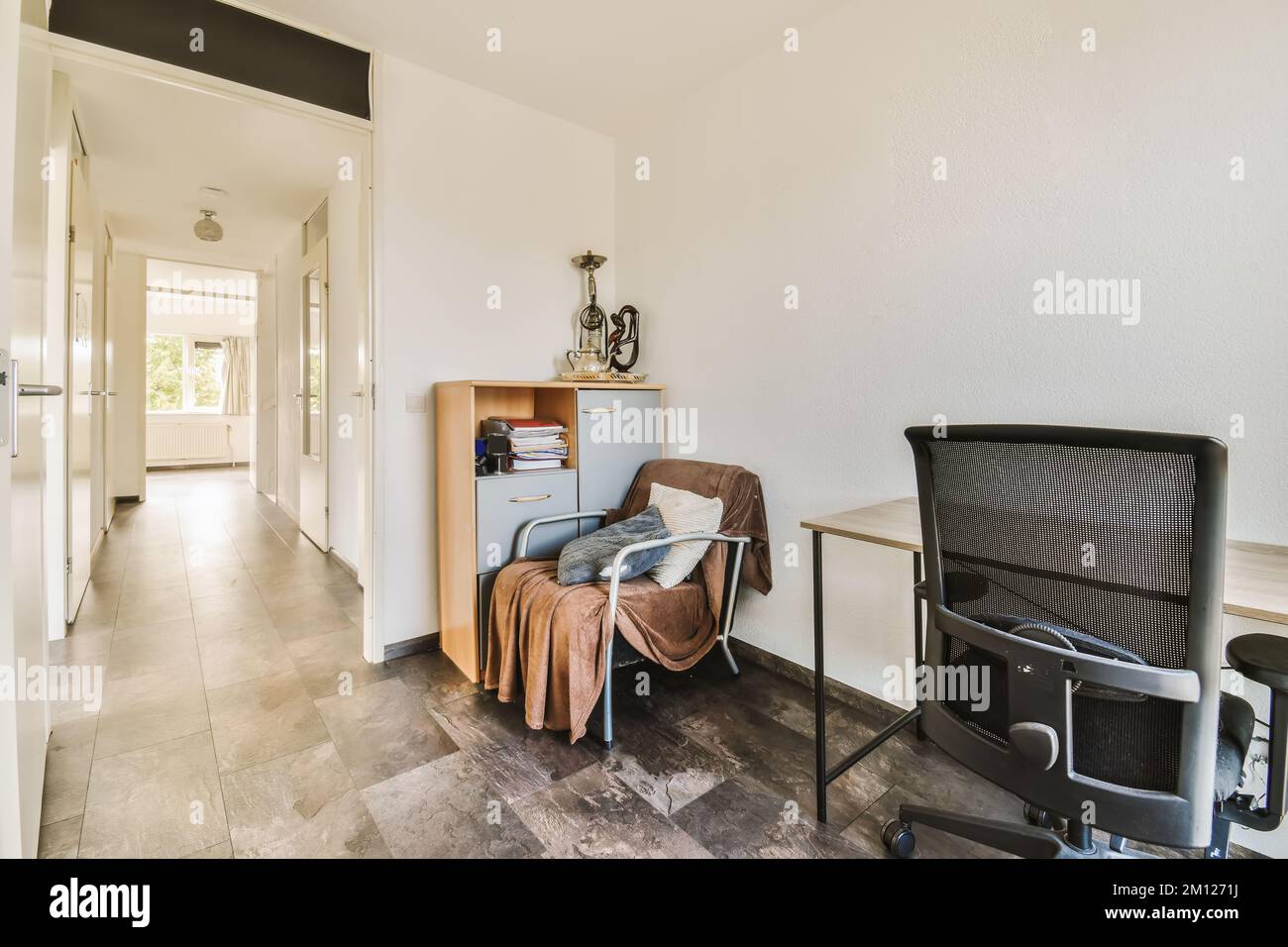 a room with a desk, chair and computer on the floor in front of an open ...