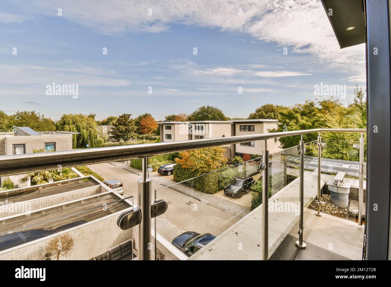 a balcony with trees and houses in the background, taken from an ...