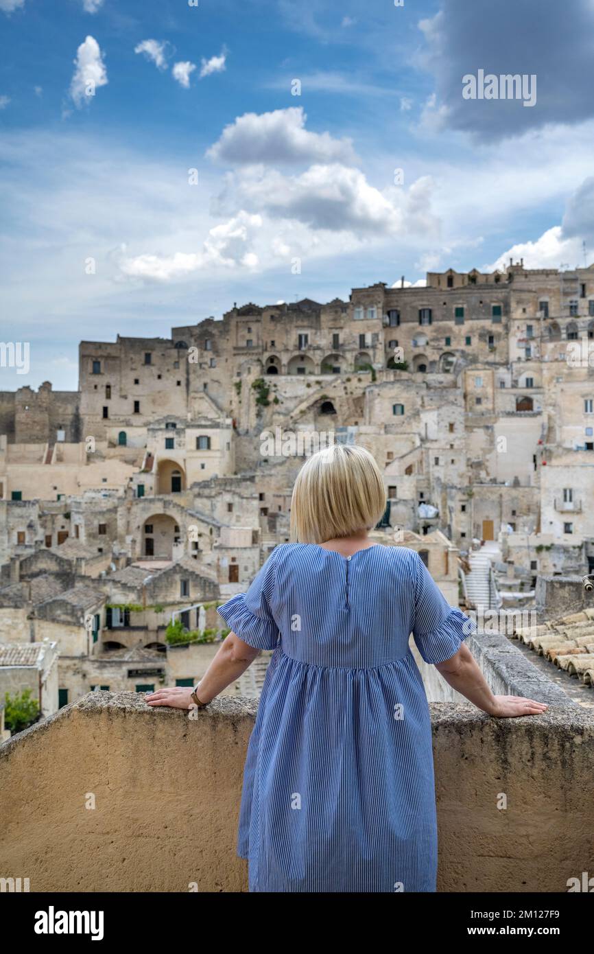 Matera, Matera province, Basilicata, Italy, Europe. A woman visits the ...