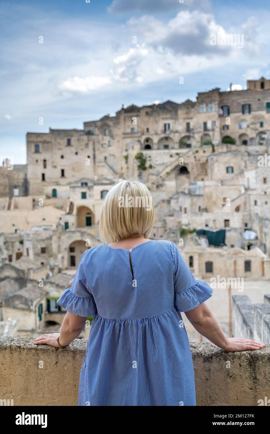 Matera, Matera province, Basilicata, Italy, Europe. A woman visits the ...