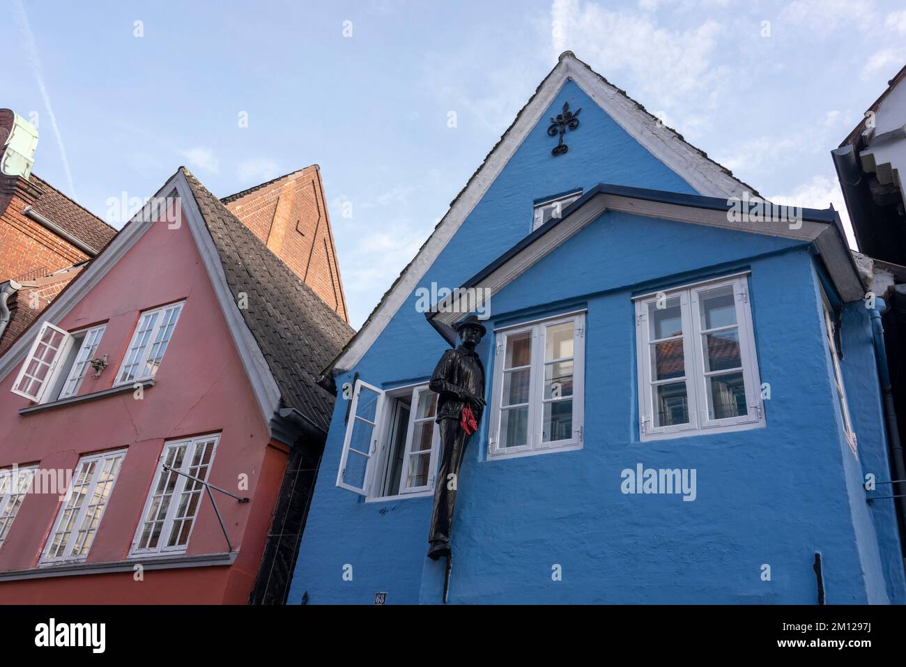 Colorful houses in the old town, male figure with red shoes ...