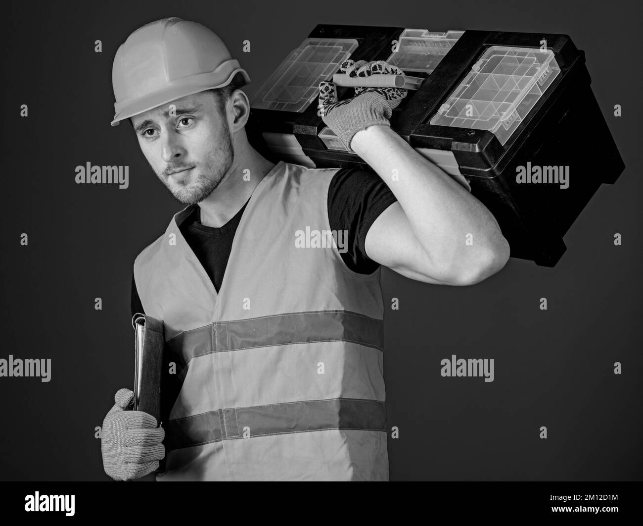 Man in helmet, hard hat holds toolbox and folder with documents, blue ...