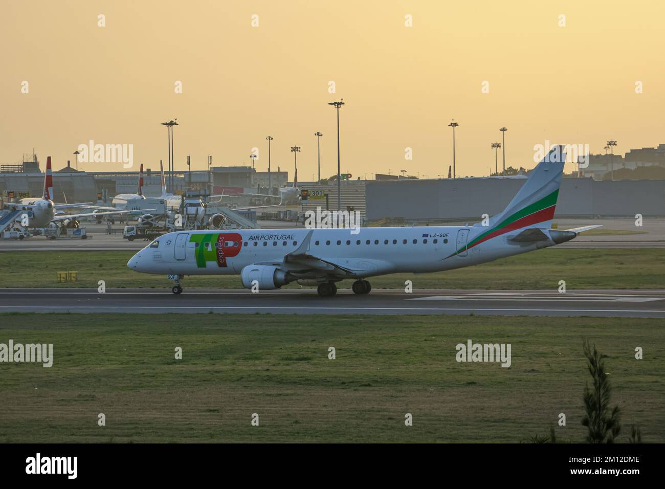 A side view of the TAP Air Portugal airplane at sunset in Humberto ...