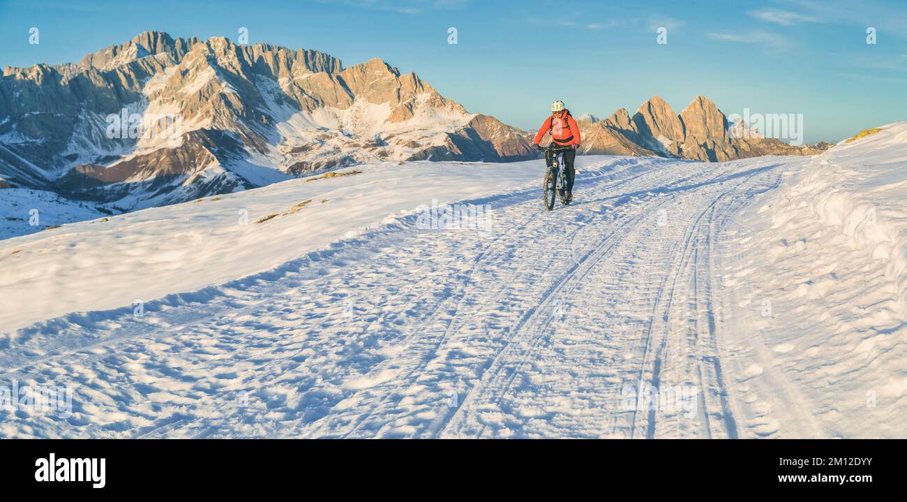 Italy, Veneto, province of Belluno, Dolomites, cyclist riding a modern ...