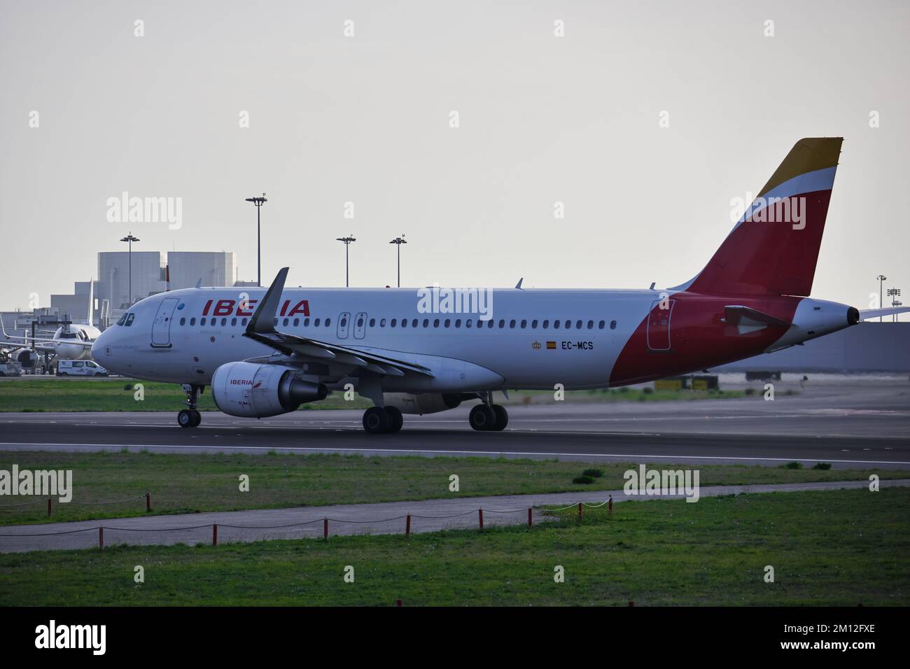 A side view of the Iberia airline airplane at sunset in Humberto ...