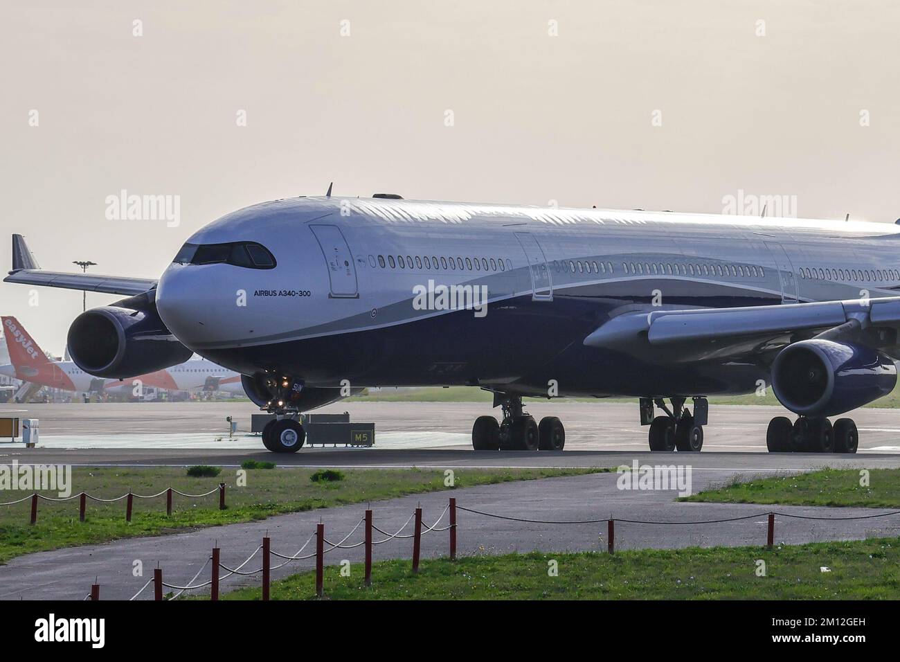A view of the Hi Fly airplane at sunset in Humberto Delgado Airport ...