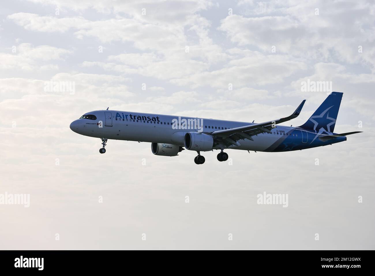 A side view of the TAP Air Portugal airplane flying in the blue sky ...