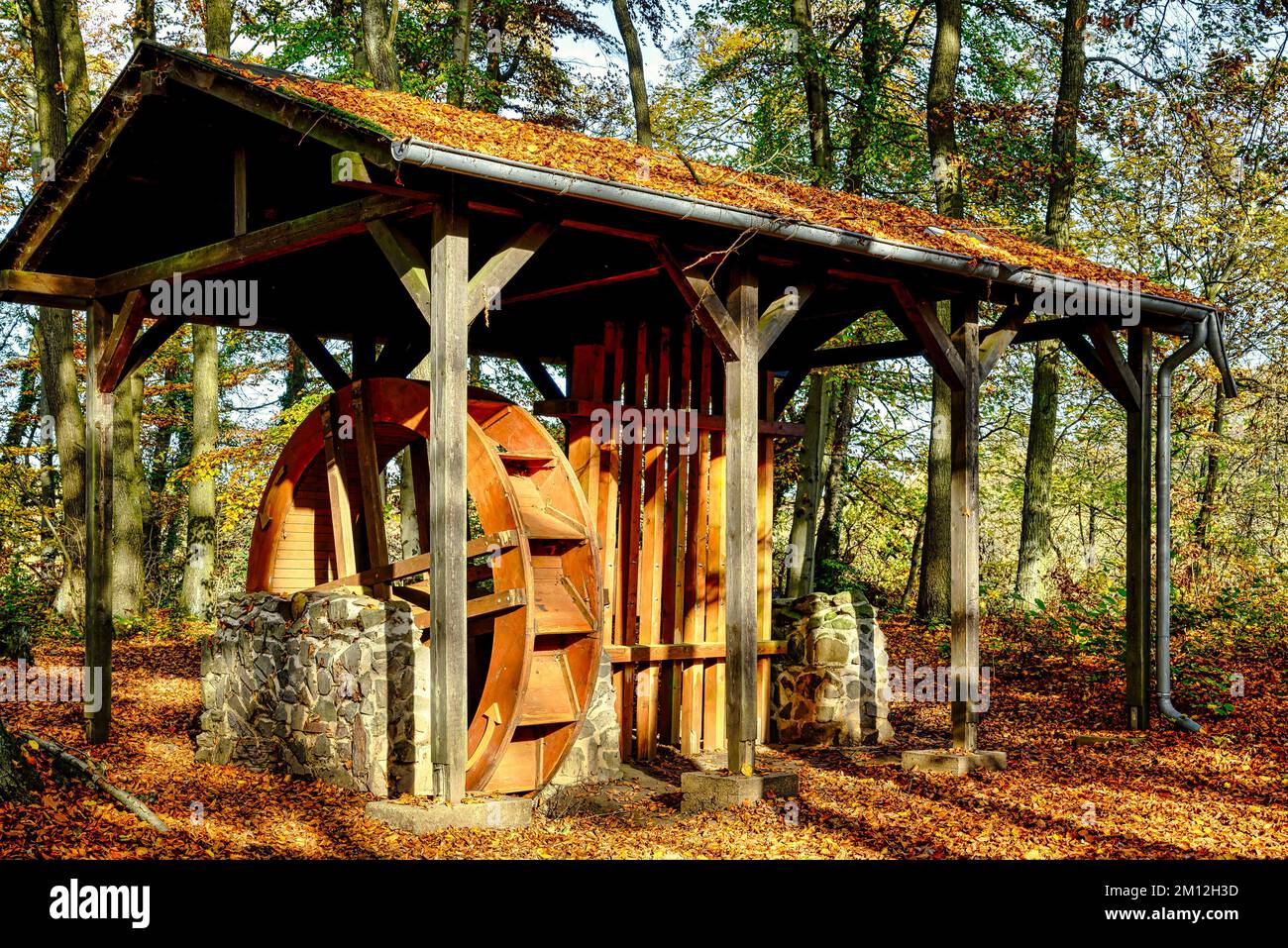 A view of a watermill in the forest with fall colors Stock Photo - Alamy
