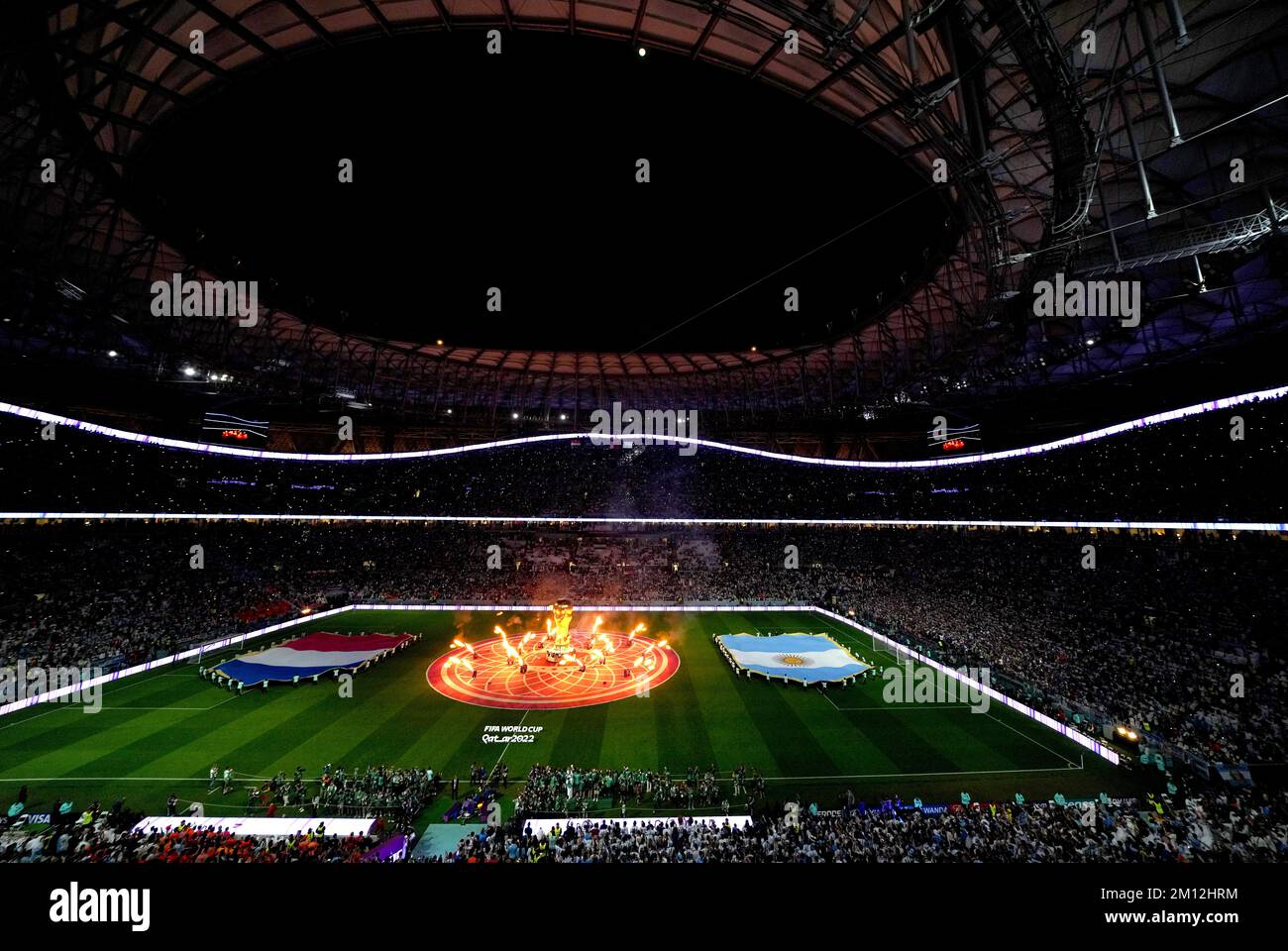 Pyrotechnics go off around a large scale replica of the FIFA World Cup ...