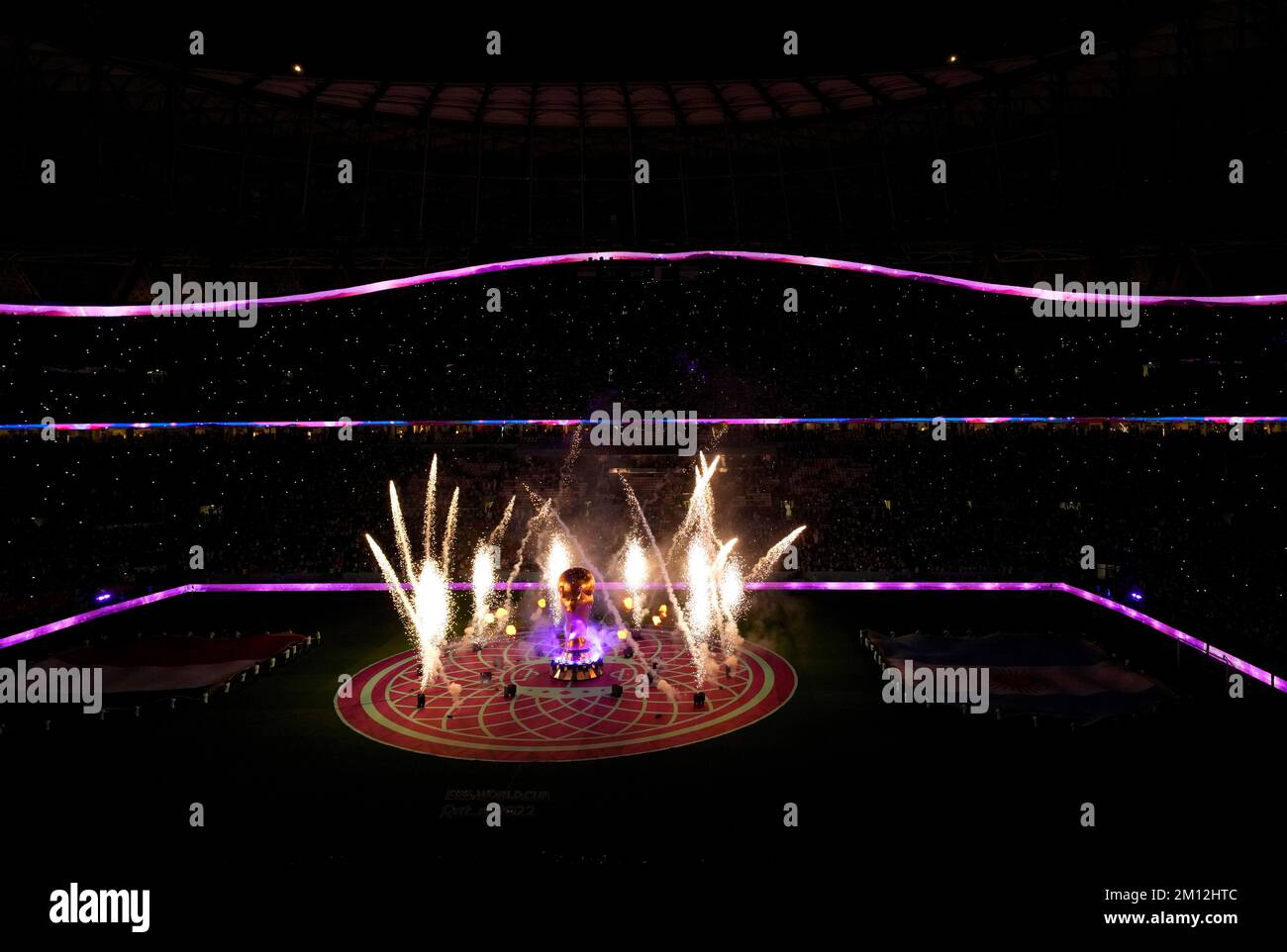 Pyrotechnics go off around a large scale replica of the FIFA World Cup ...