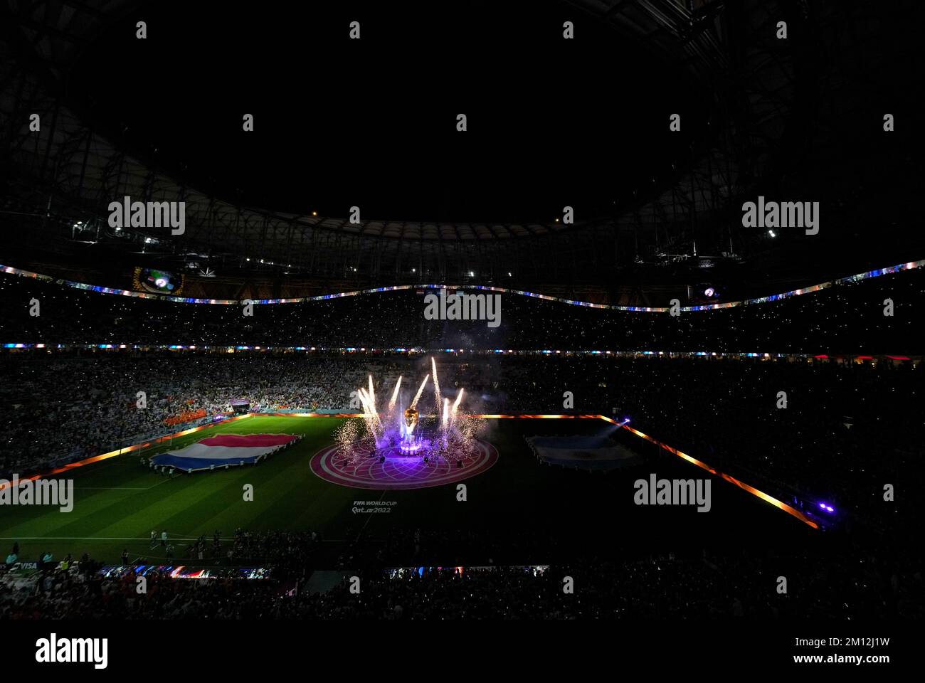 Pyrotechnics go off around a large scale replica of the FIFA World Cup ...