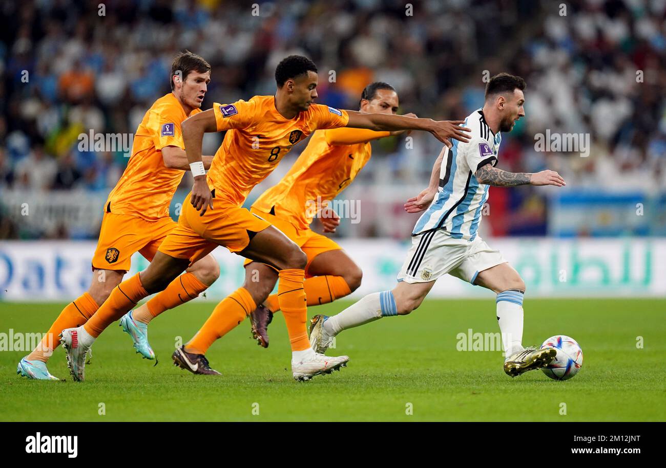 Argentina's Lionel Messi gets away from Netherlands' Cody Gakpo, Marten ...