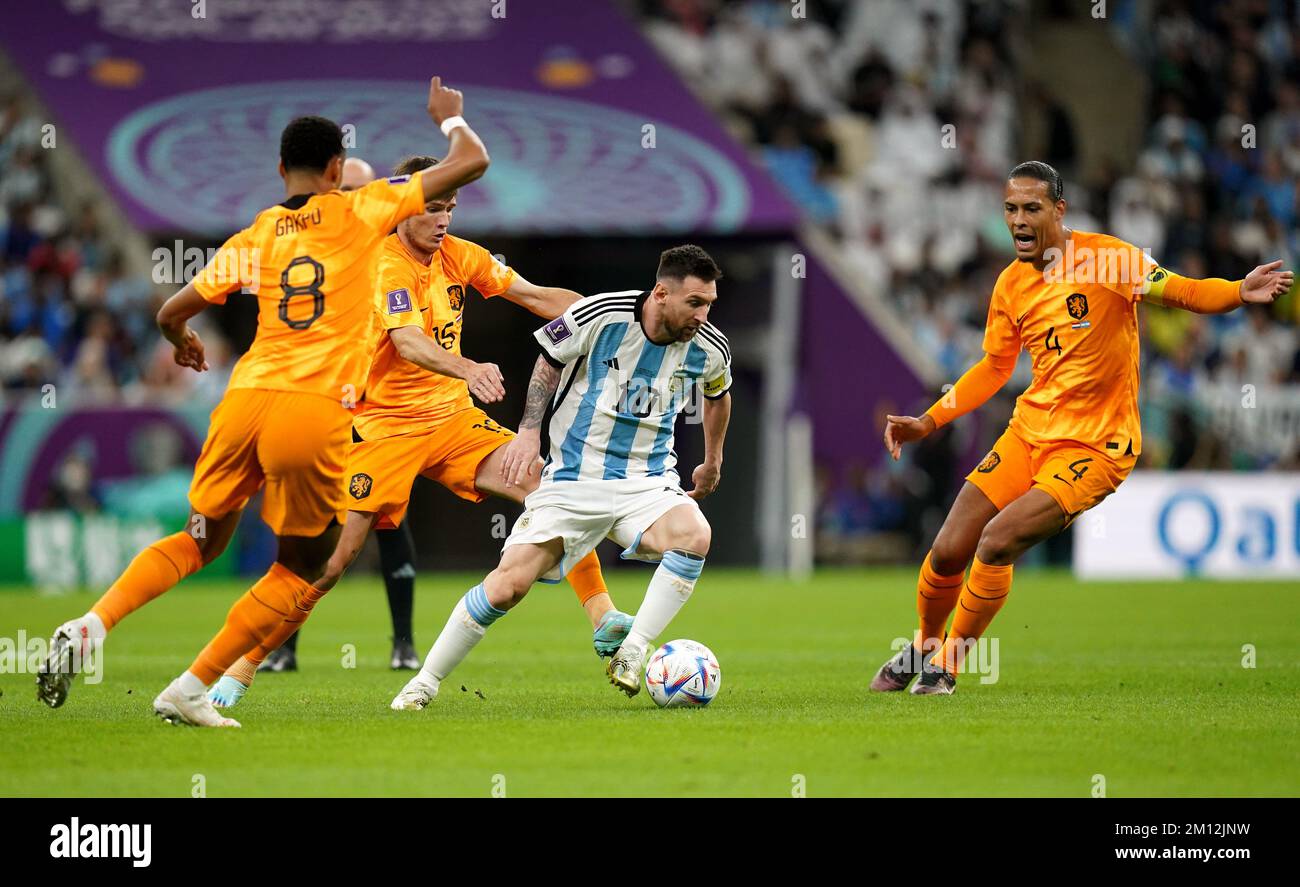 Argentina's Lionel Messi (centre) gets away from Netherlands' Cody ...