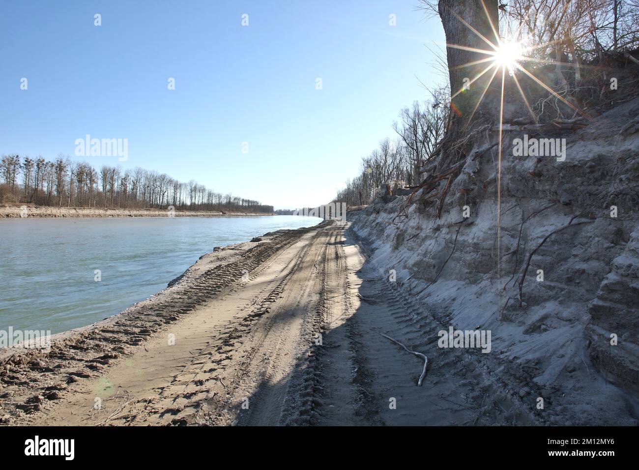 Steep wall of sand and dredge marks on a river bank, renaturation of ...