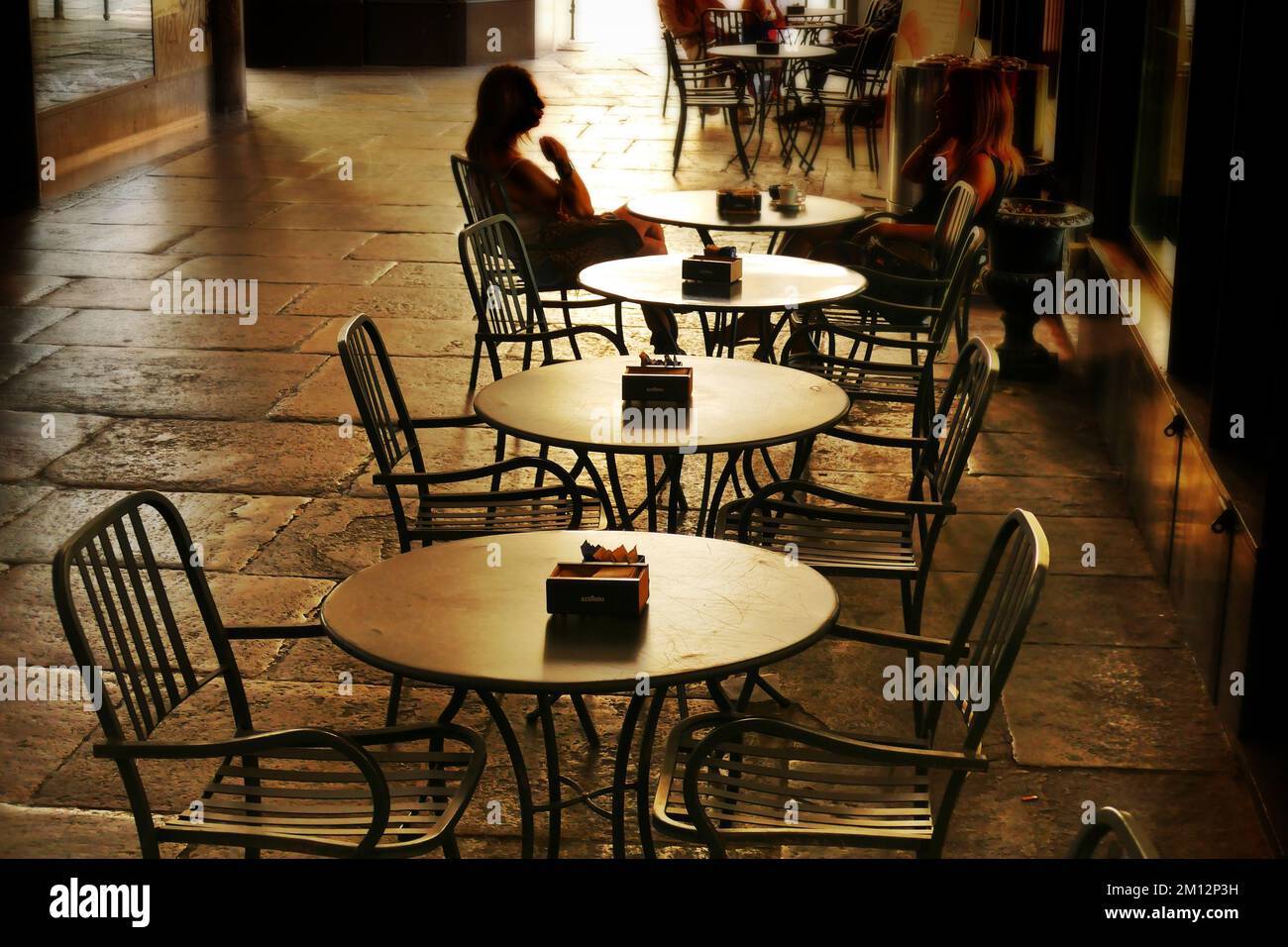 A high angle shot of an outdoor cafe on a sidewalk in the evening Stock ...