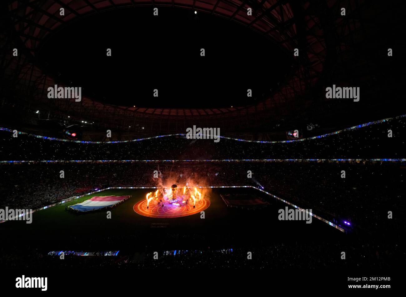 Pyrotechnics go off around a large scale replica of the FIFA World Cup ...