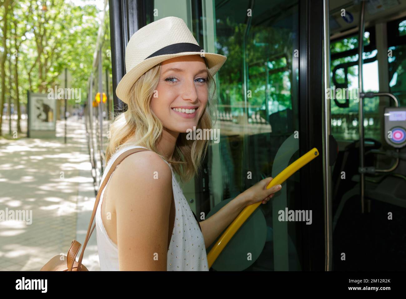 portrait of a happy woman boarding city bus Stock Photo - Alamy