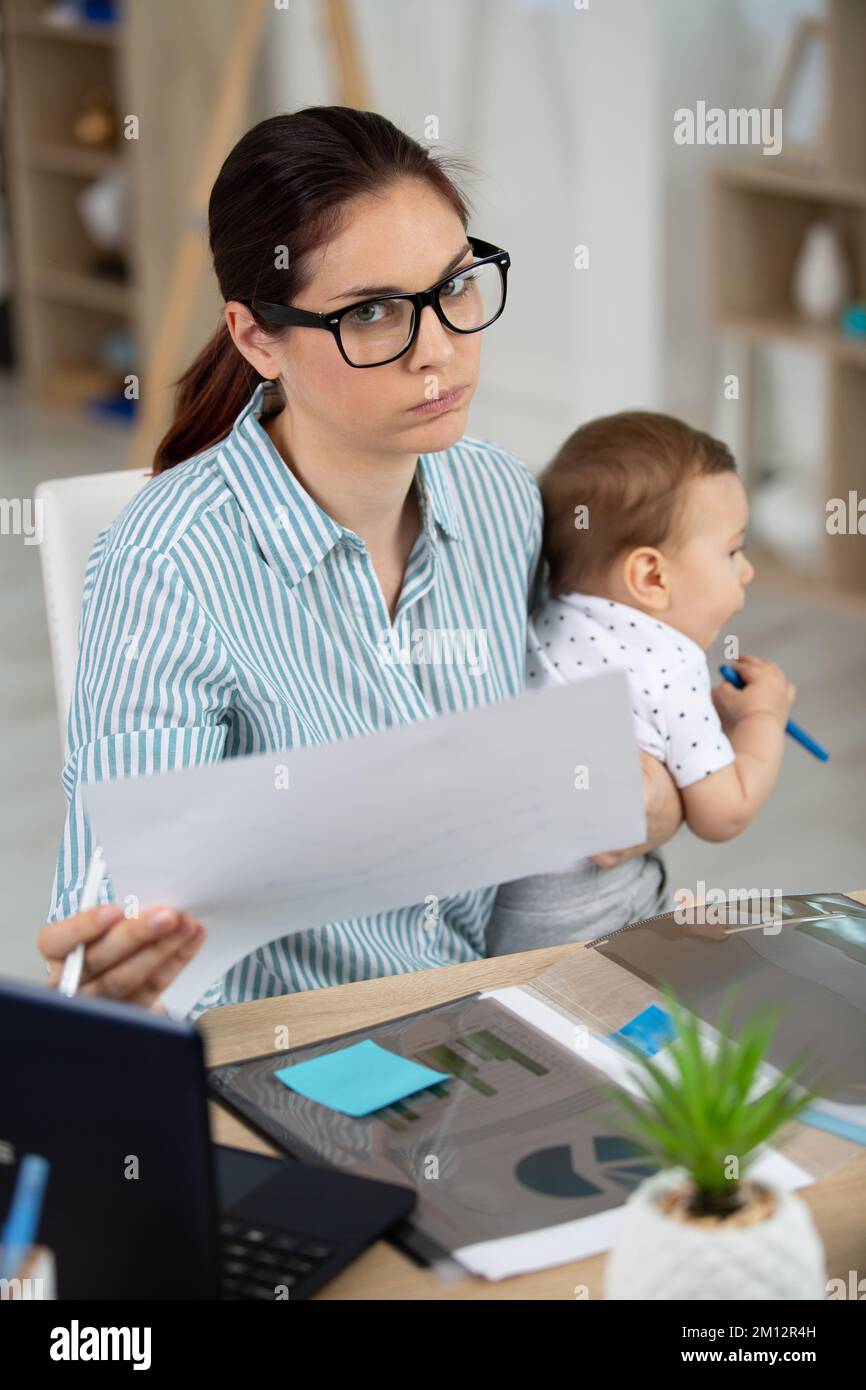exhausted working mom at office with her baby Stock Photo - Alamy