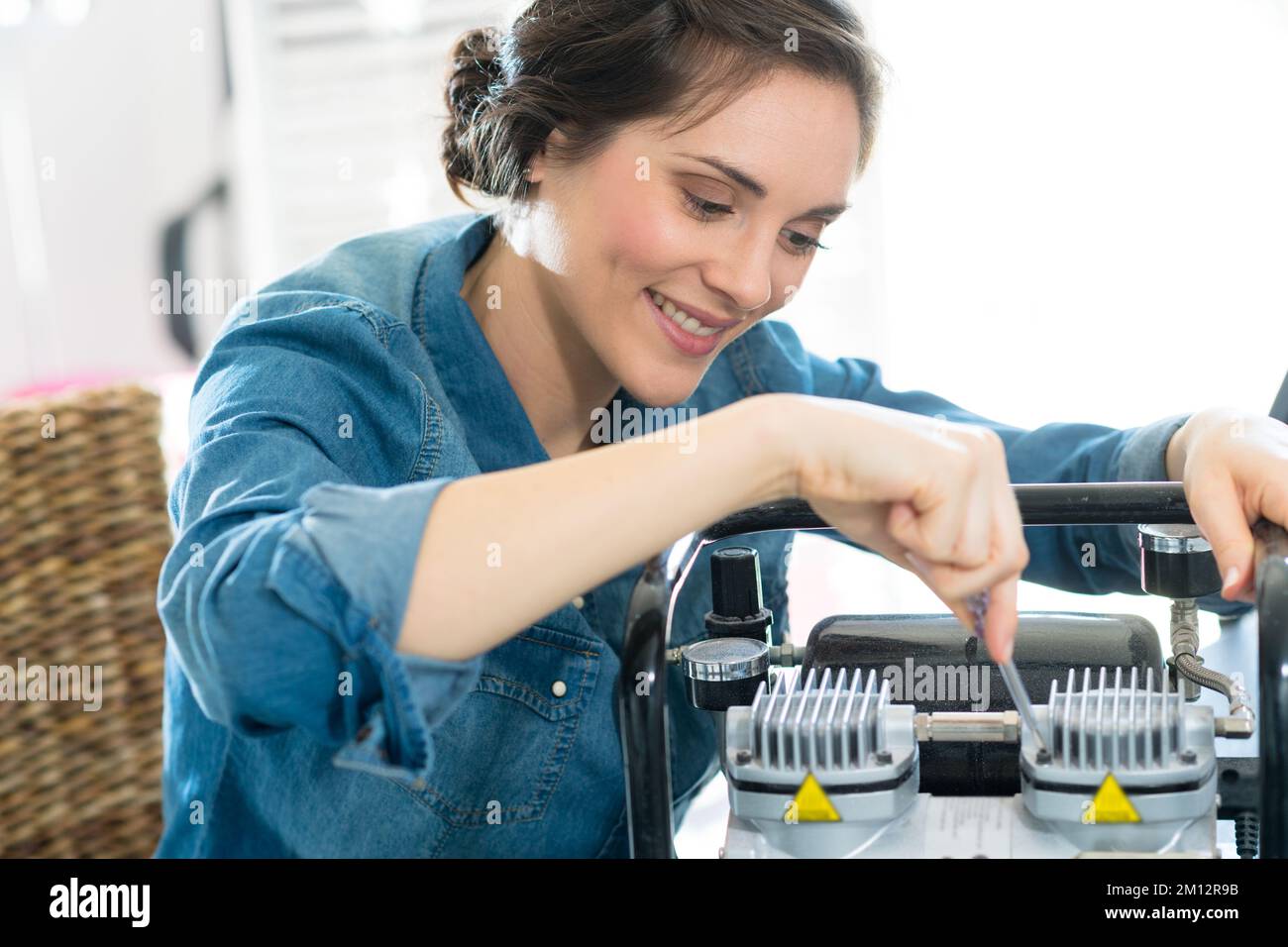 Female checking machine battery hi-res stock photography and images - Alamy