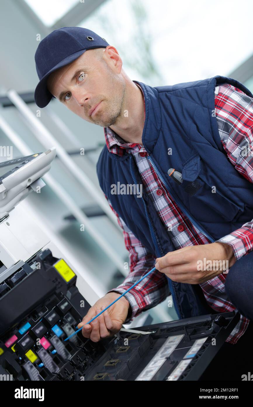 a printer technician posing seriously Stock Photo - Alamy