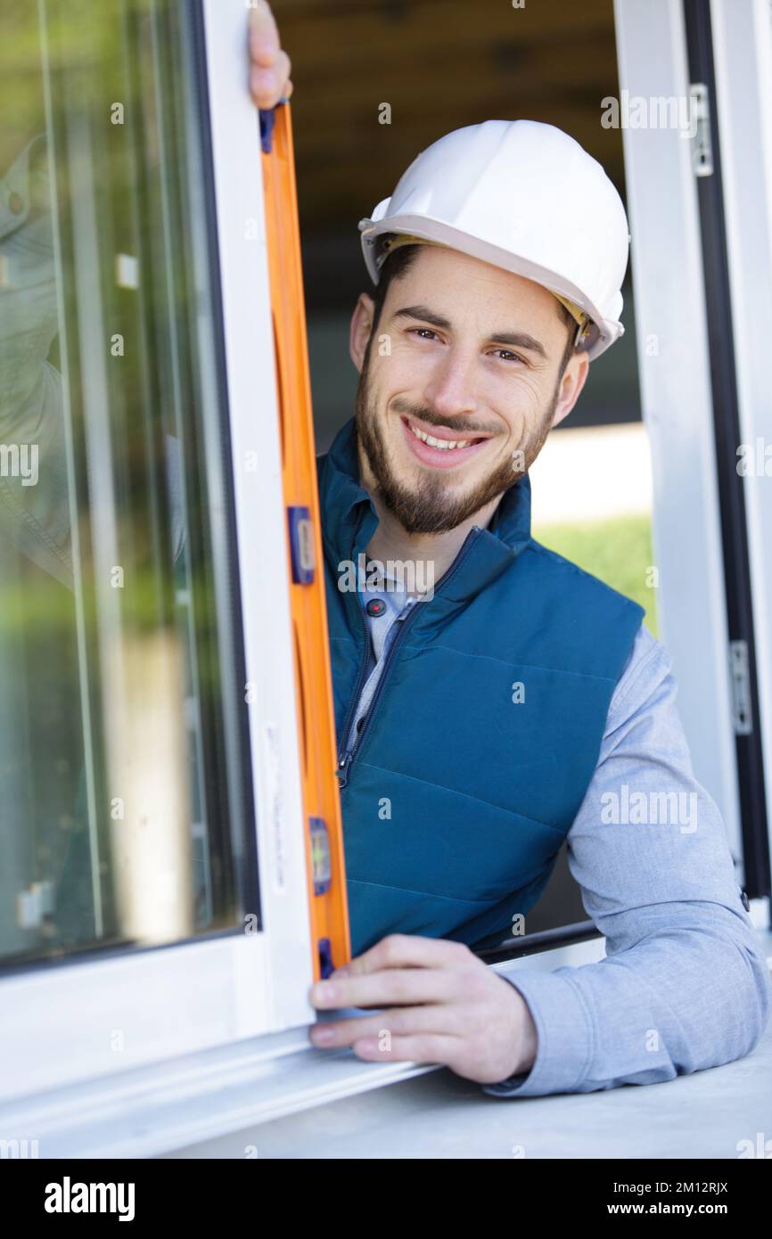 man is verifying window using a spirit level Stock Photo - Alamy