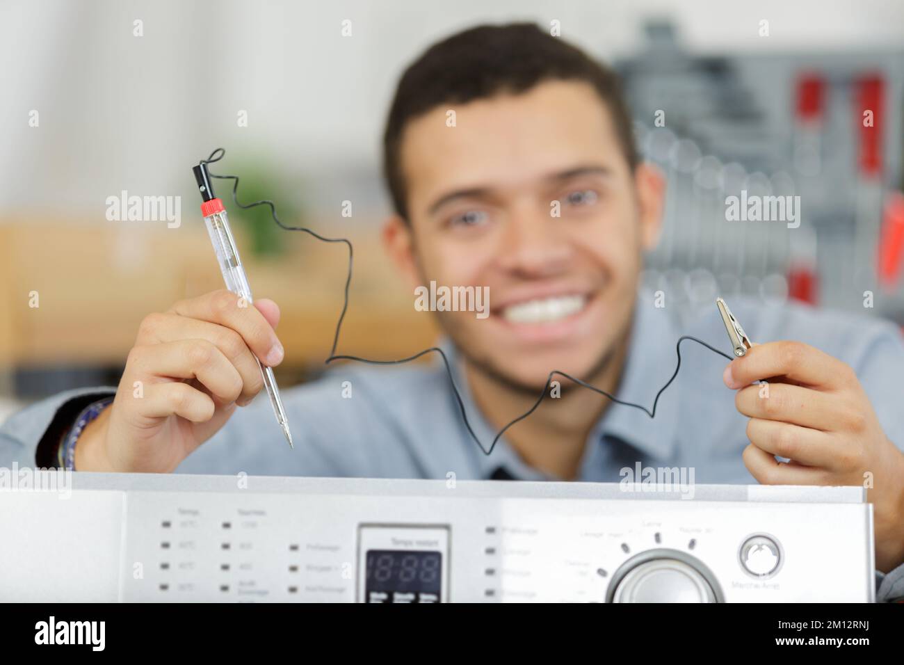 serviceman holding device for testing power Stock Photo - Alamy