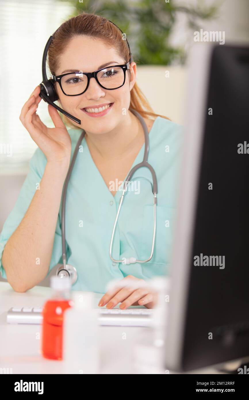 Happy female doctor headset hi-res stock photography and images - Alamy