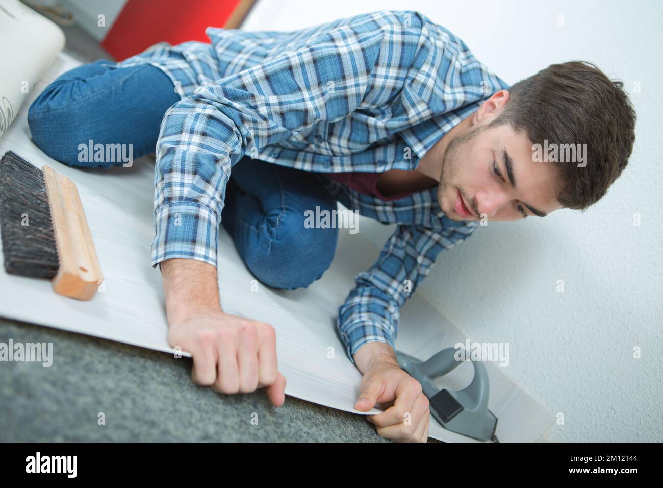 Young man roll carpet hi-res stock photography and images - Alamy