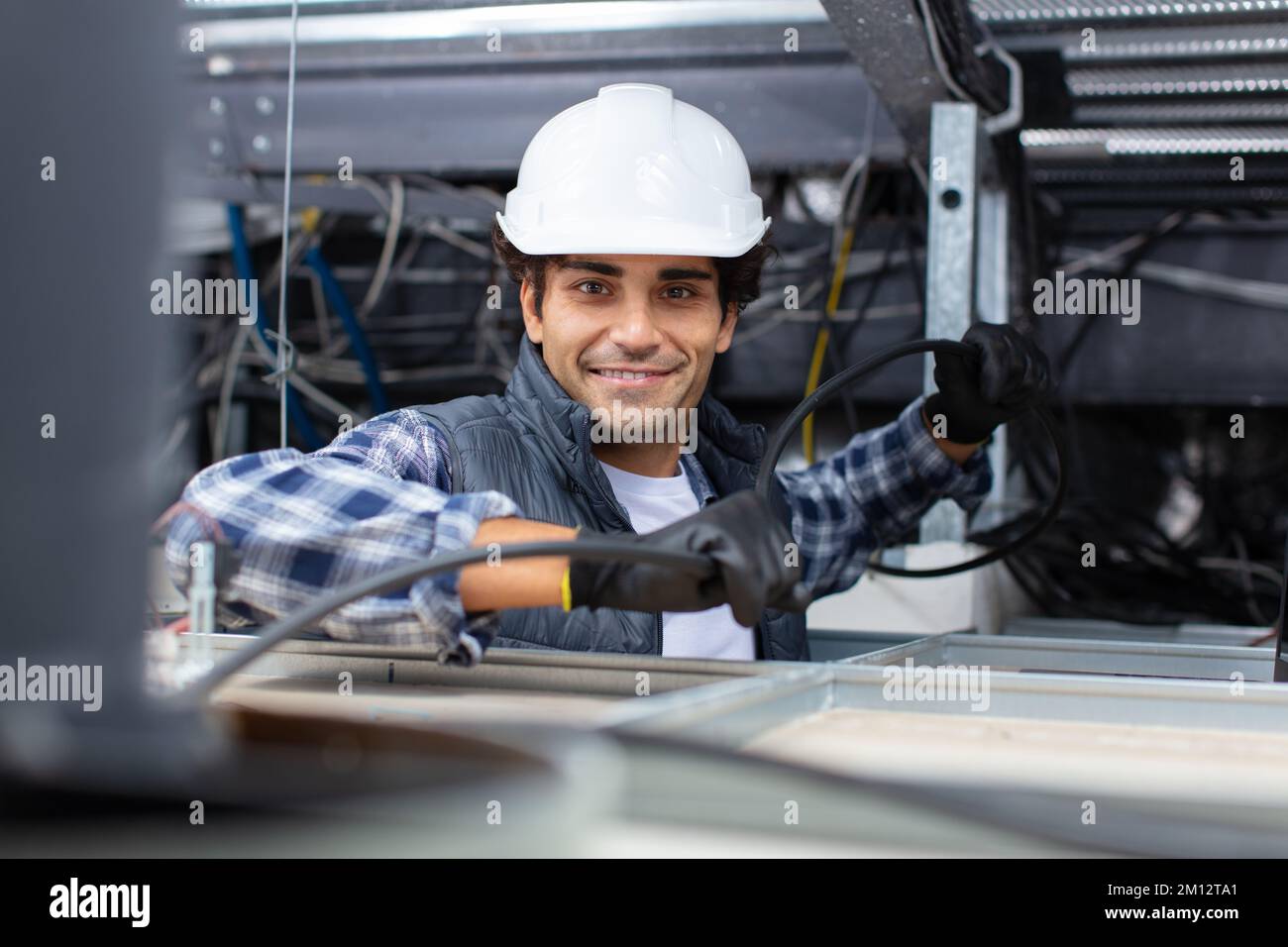 young man electrician wiring inside ceiling Stock Photo - Alamy
