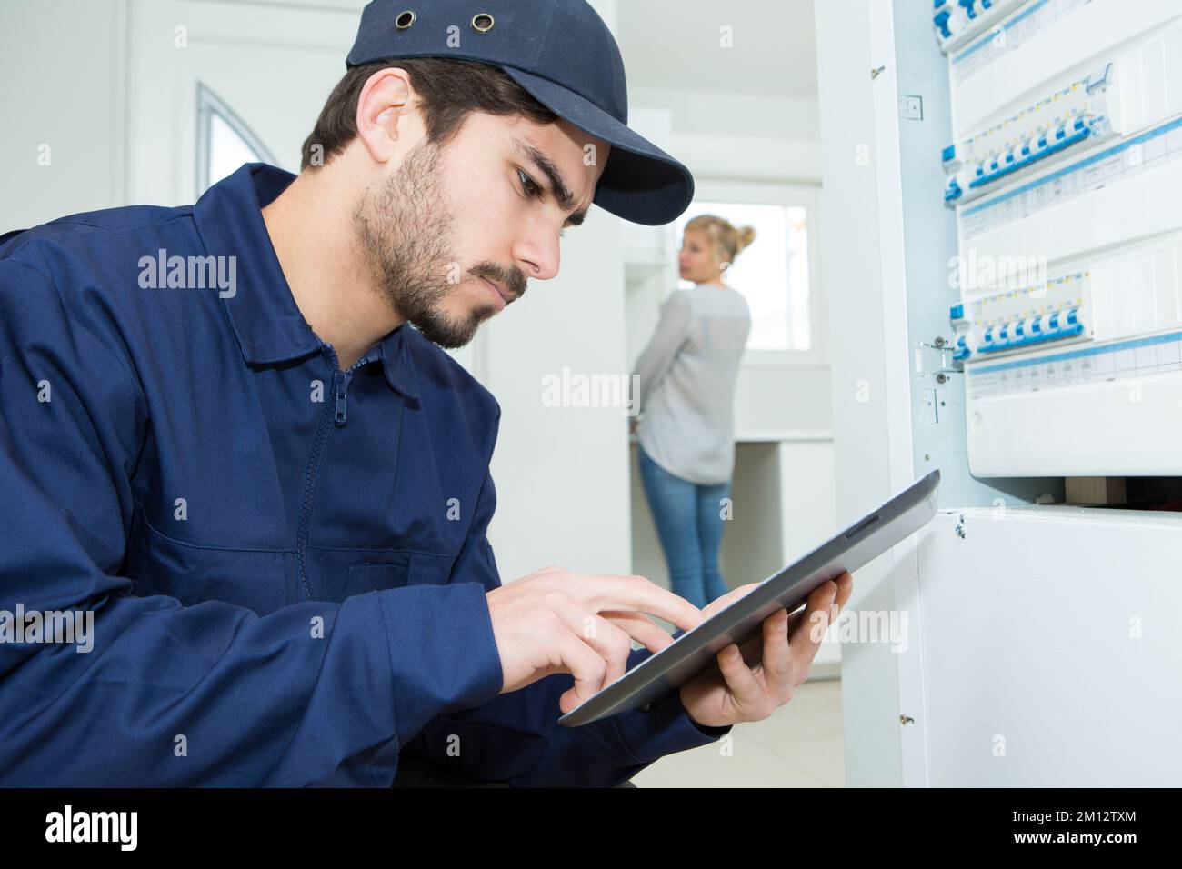 man working on control box Stock Photo - Alamy