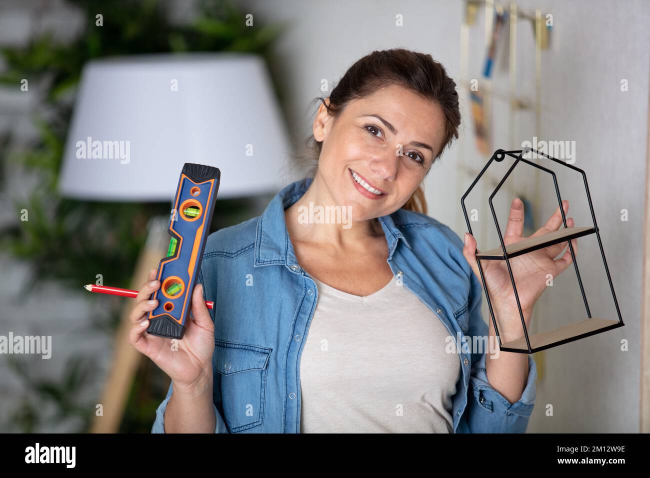 Girl putting up decoration hi-res stock photography and images - Alamy