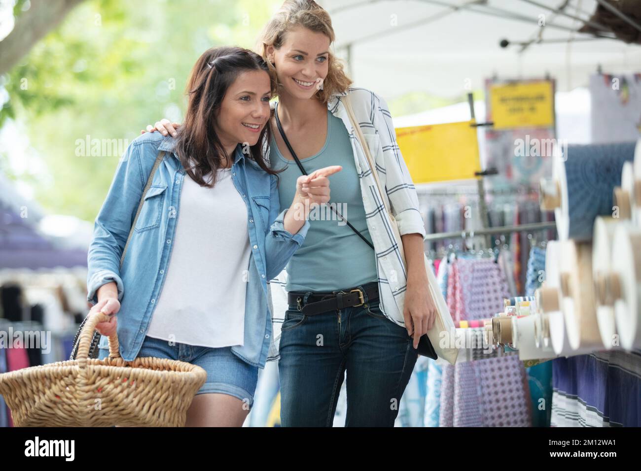 portrait of two women shopping together in the street market Stock ...