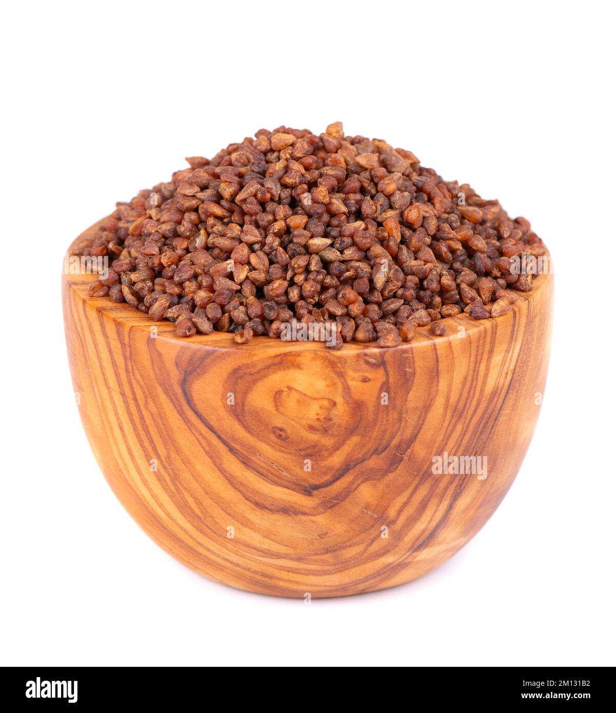 Buckwheat tea in wooden bowl, isolated on white background. Whole ...