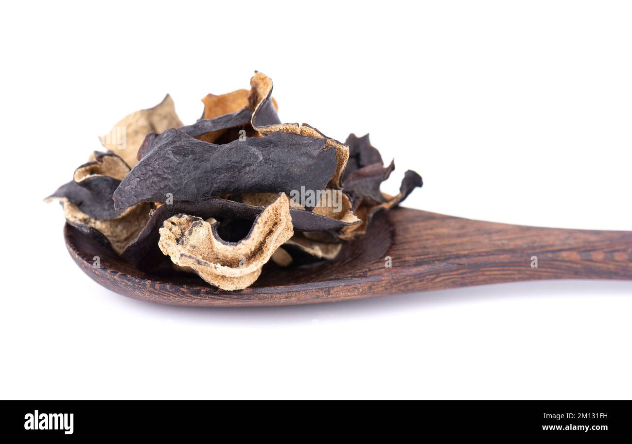 Dry black fungus in wooden spoon, isolated on white background. Chinese ...