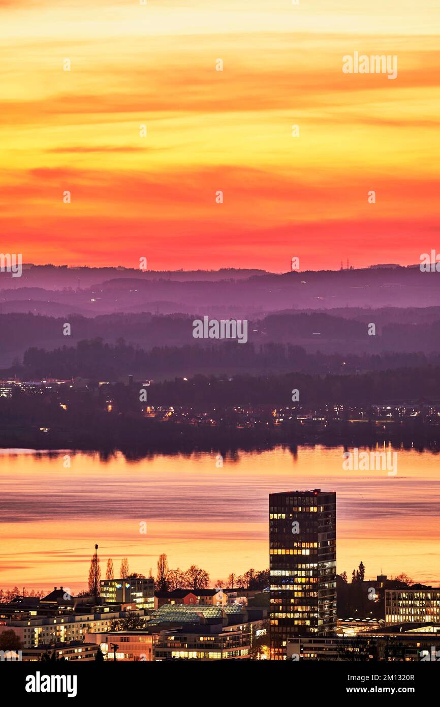 Evening mood with skyline and Lake Zug in the foreground the high-rise ...