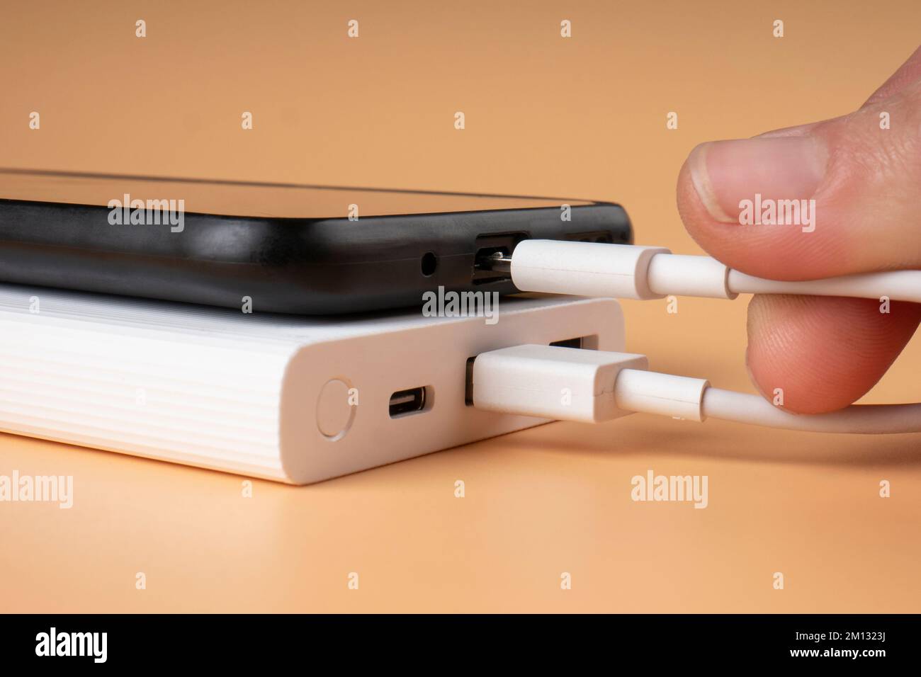 charging smartphone from power bank, extra battery for phone Stock ...