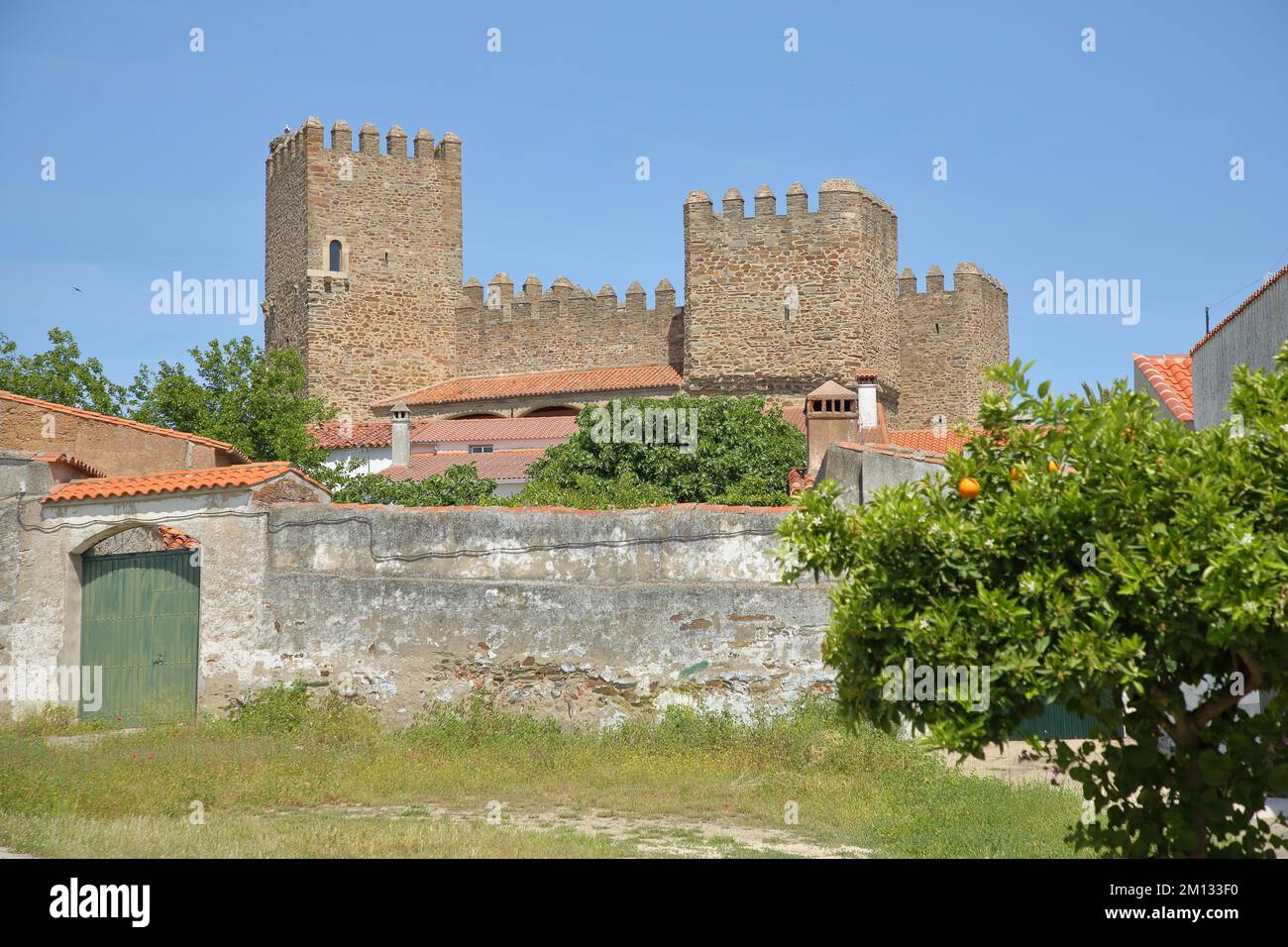 Historic fortification Castillo Castle with orange tree, towers, Monroy ...