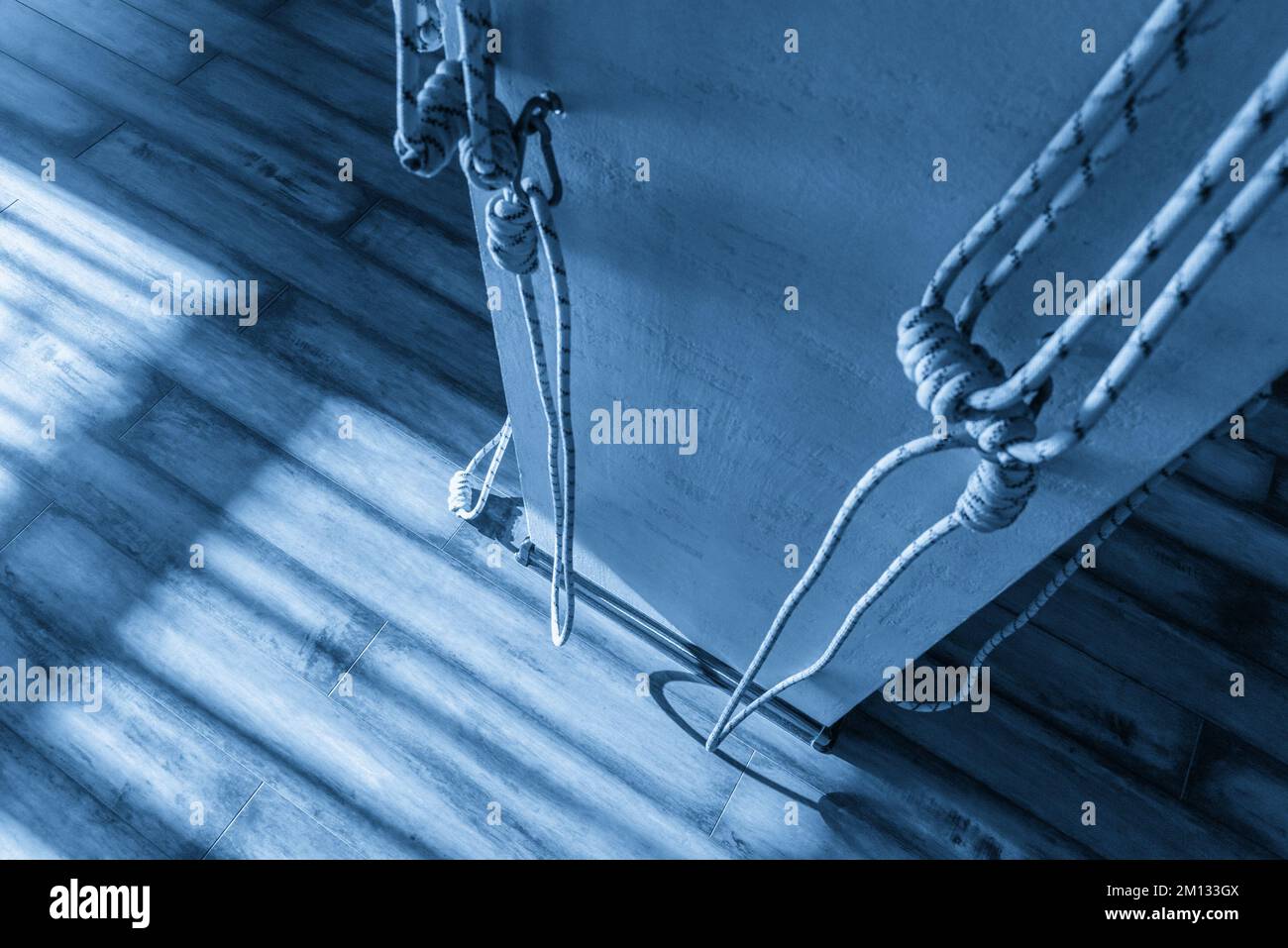 Yoga ropes hanging on empty studio wall. Iyengar yoga Stock Photo - Alamy