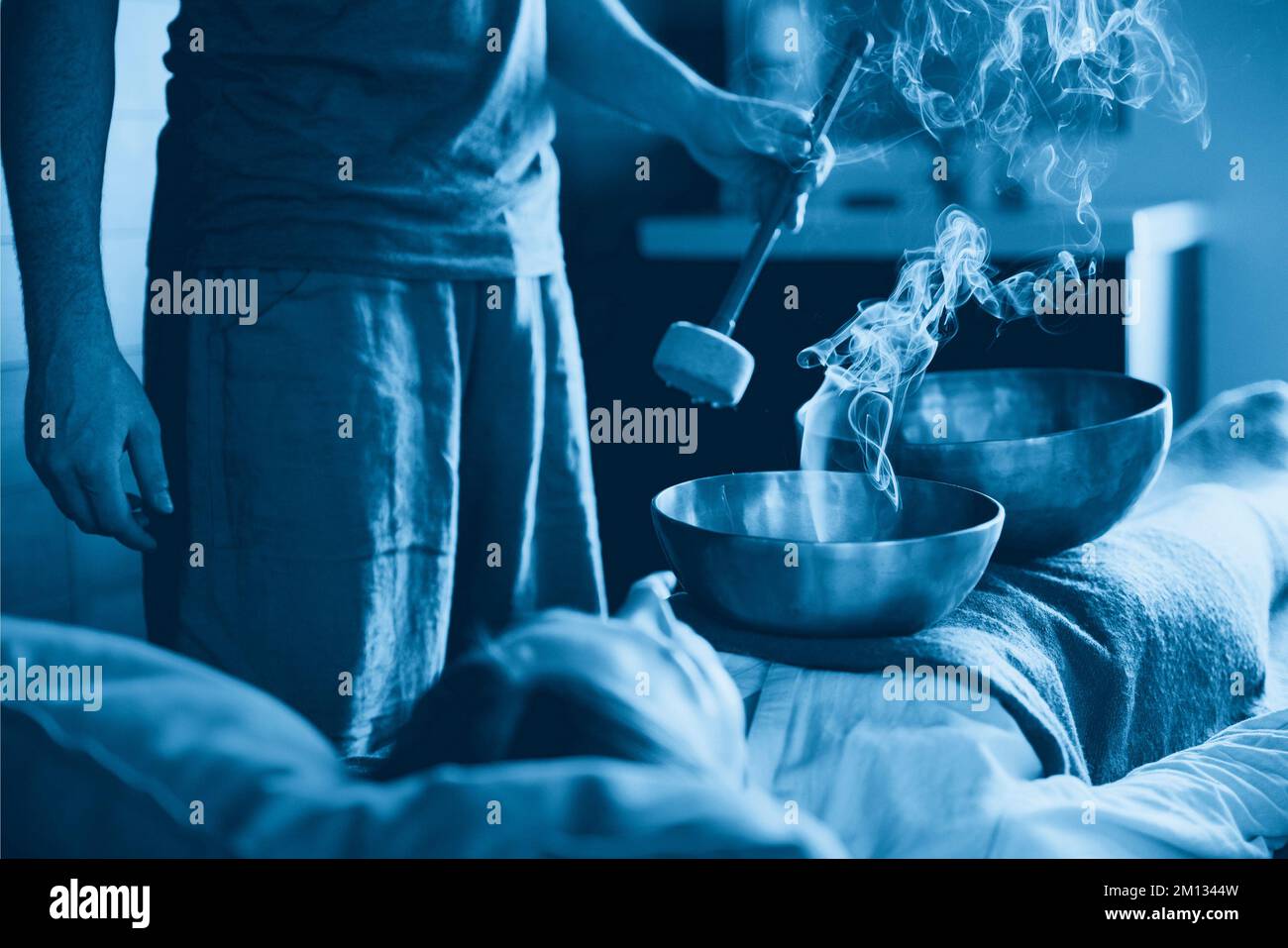 Tibetan singing bowls with smoke in sound therapy in spa center Stock ...